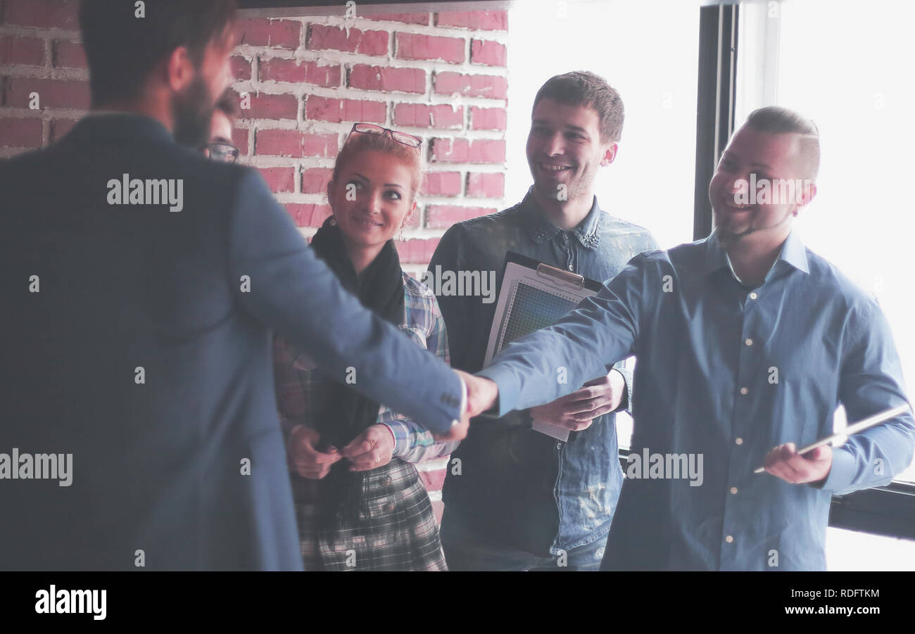 handshake partners in the creative office Stock Photo - Alamy