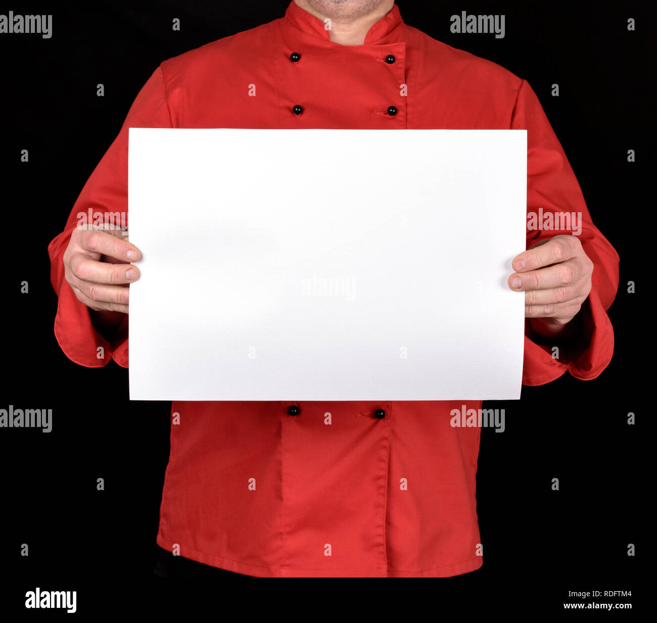 chef in red uniform holding a blank white paper sheet on a black ...