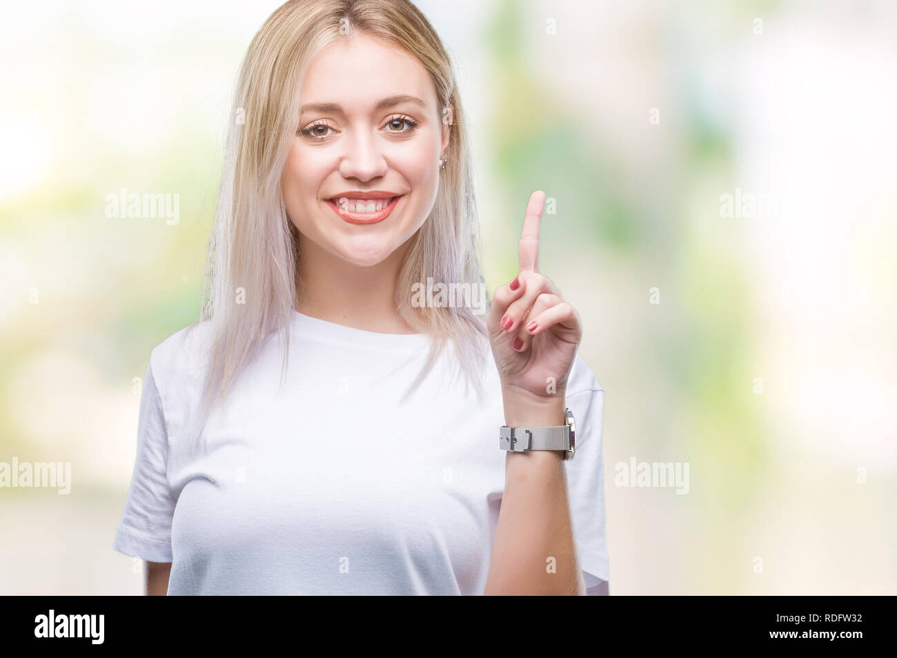 Young blonde woman over isolated background showing and pointing up ...
