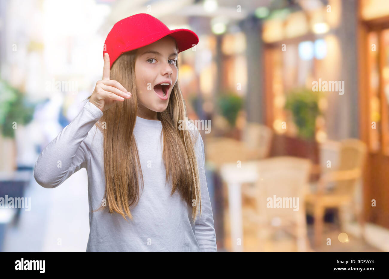 Young beautiful girl wearing red cap isolated background pointing ...