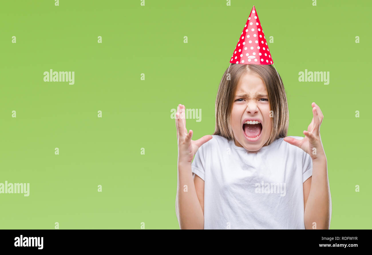 Young beautiful girl wearing birthday cap over isolated background ...