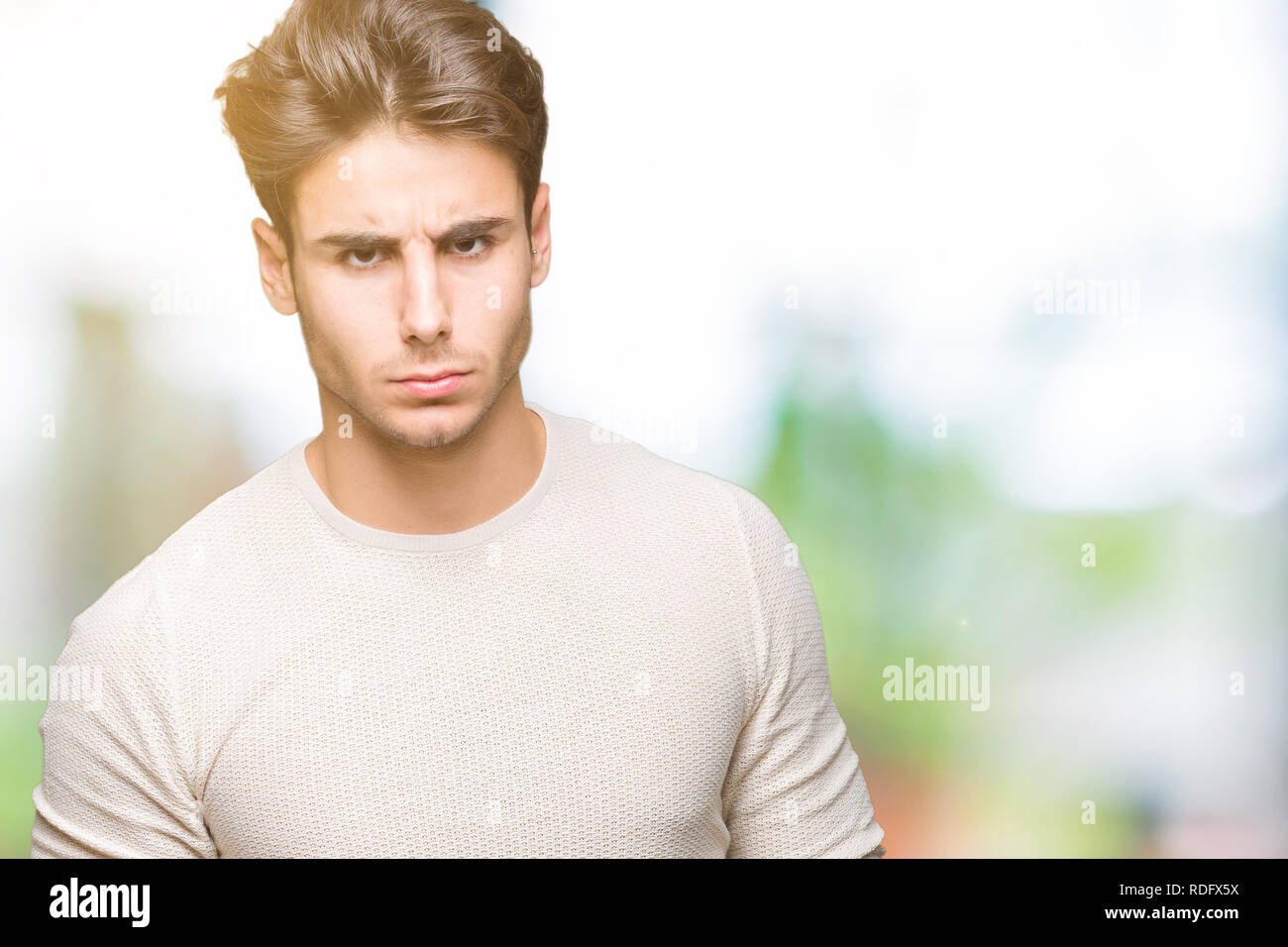 Young handsome man over isolated background skeptic and nervous ...