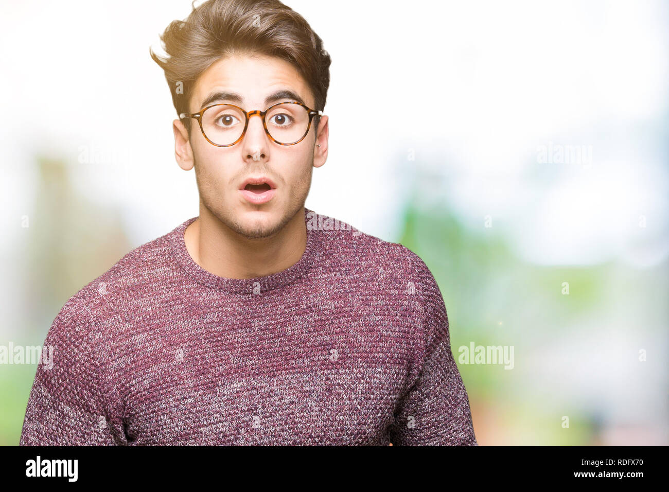 Young handsome man wearing glasses over isolated background afraid and shocked with surprise ...