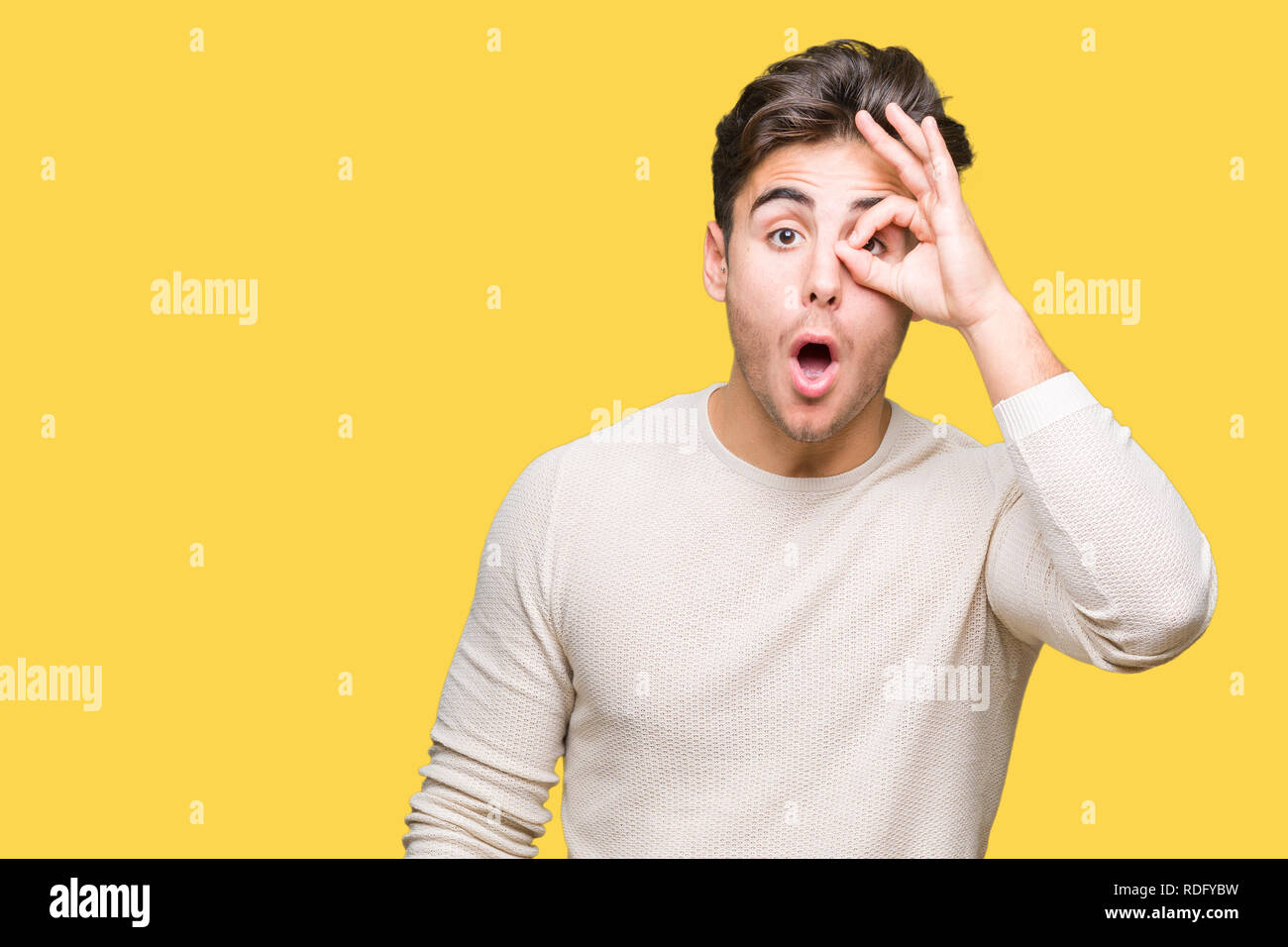 Young handsome man over isolated background doing ok gesture shocked ...