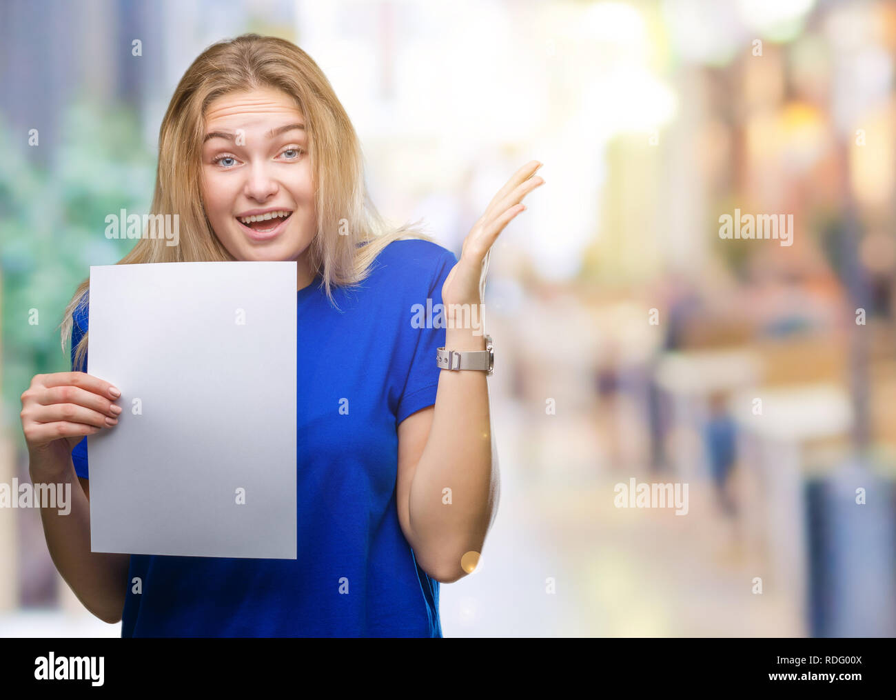 Young caucasian woman holding blank paper sheet over isolated ...