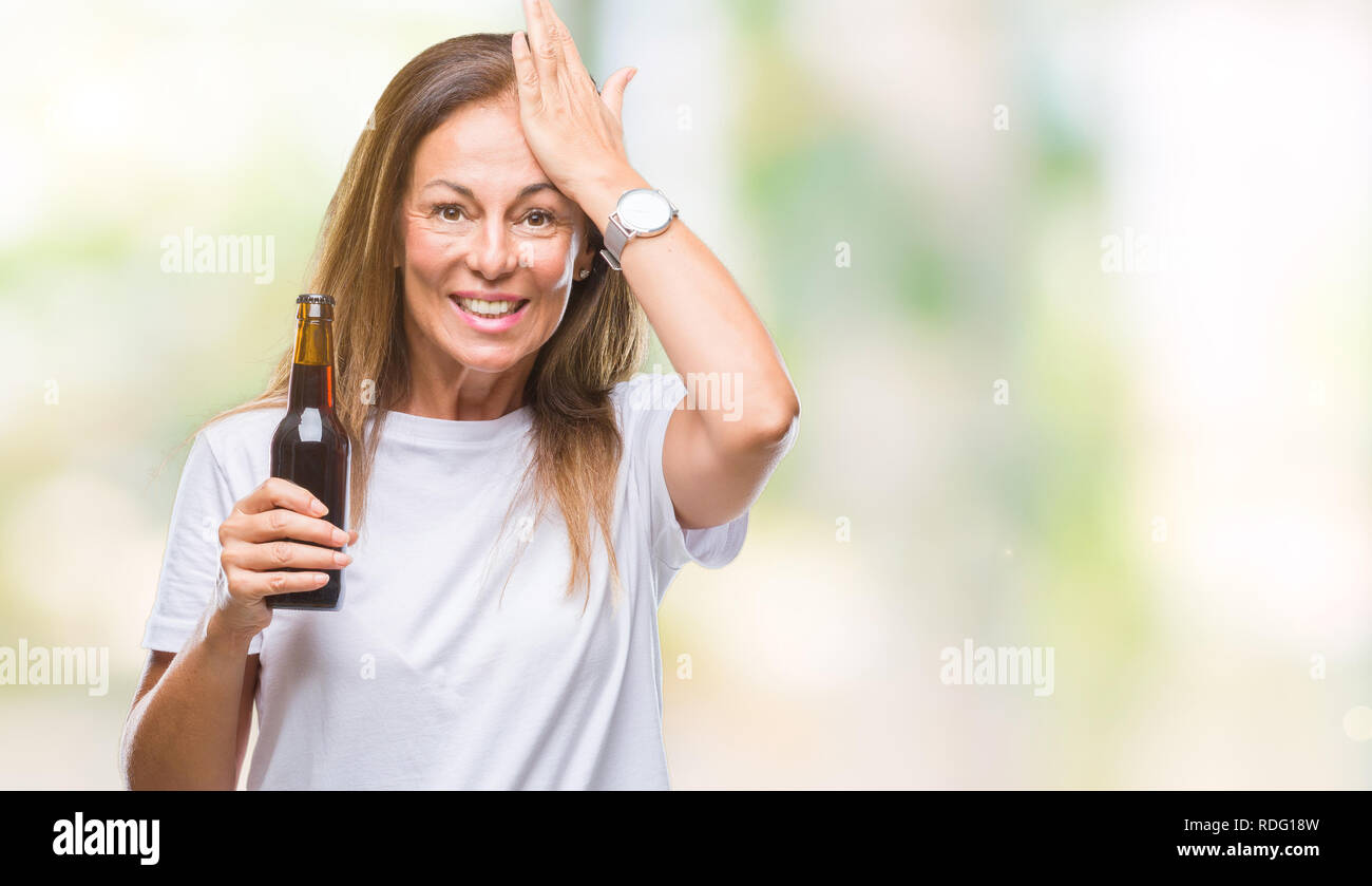 Middle age hispanic woman drinking beer over isolated background ...