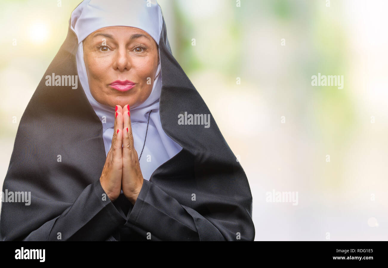 Middle age senior christian catholic nun woman over isolated background ...