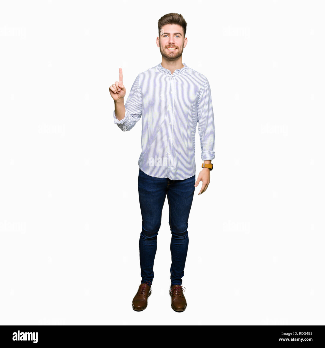 Young handsome man showing and pointing up with finger number one while ...