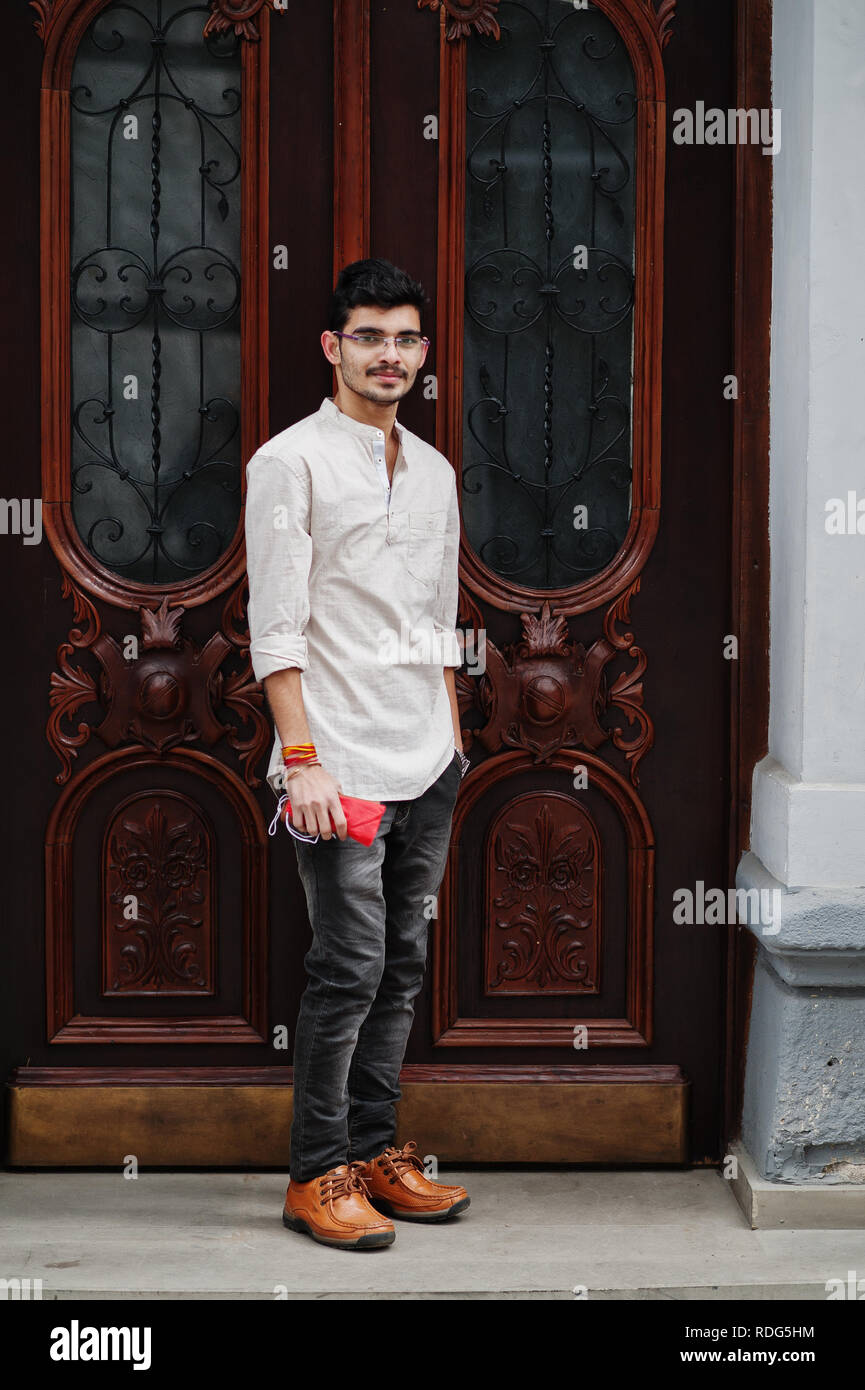 Stylish indian model man in casual clothes and eyeglasses posed outdoor ...