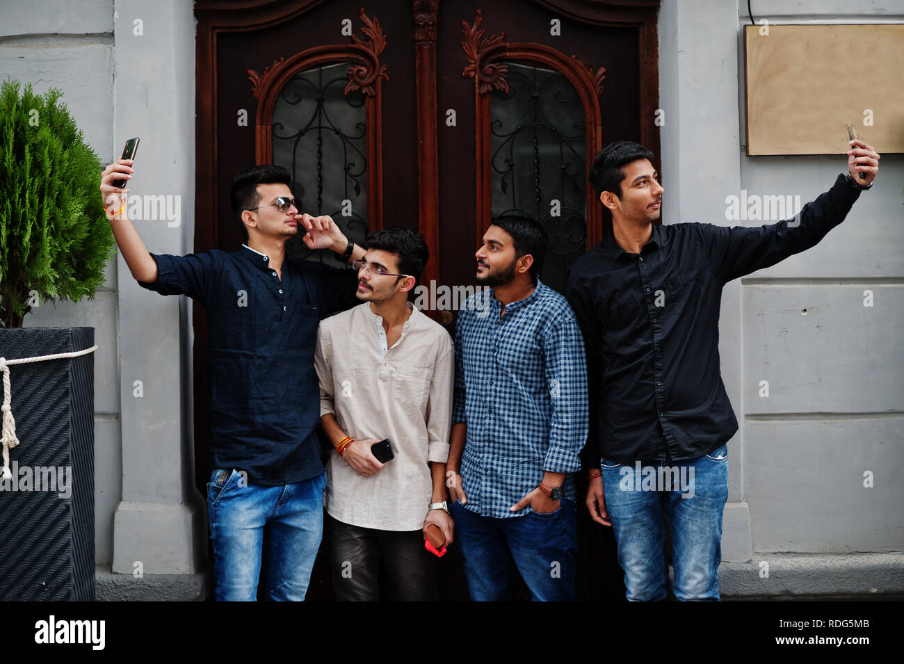 Group of four indian ethnicity friendship togetherness mans. Technology ...