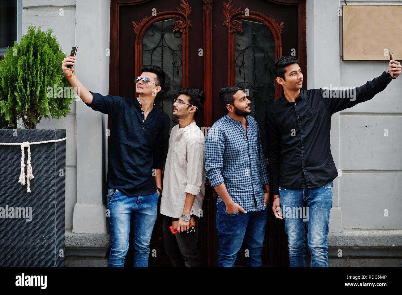 Group of four indian ethnicity friendship togetherness mans. Technology ...