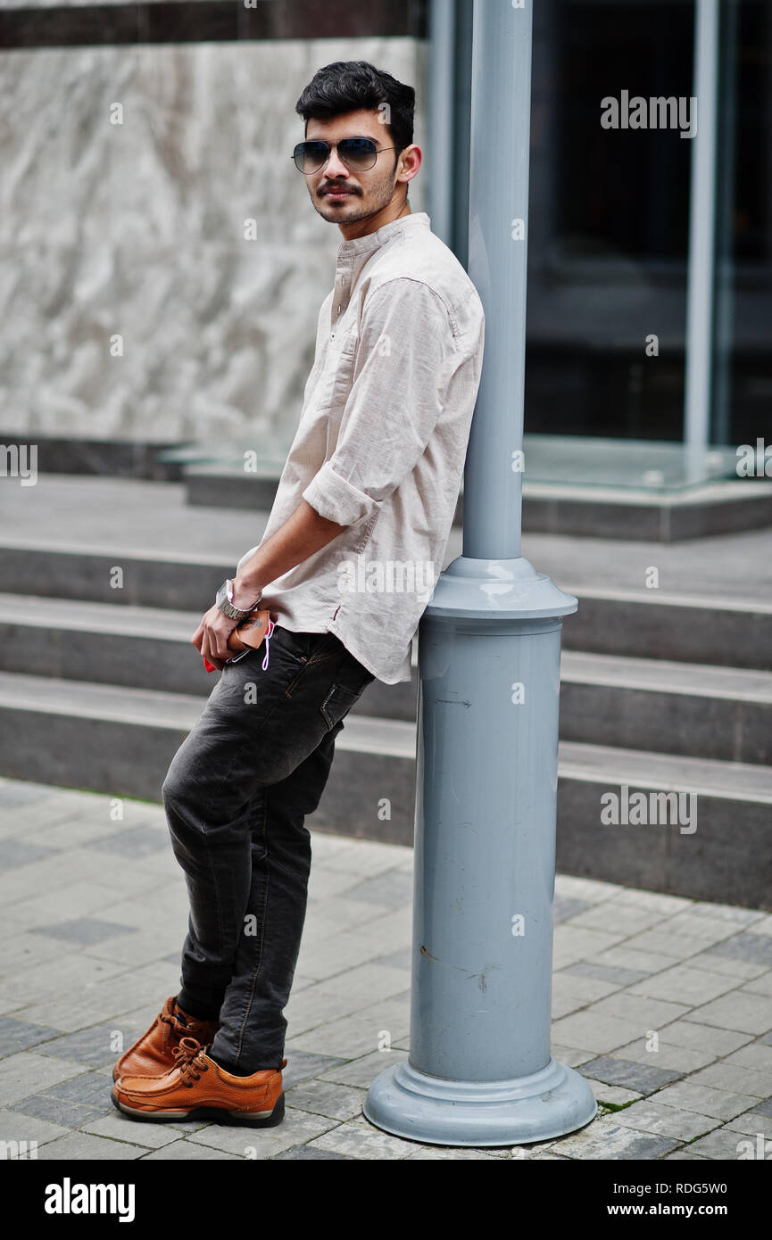 Stylish indian model man in casual clothes and sunglasses posed outdoor ...