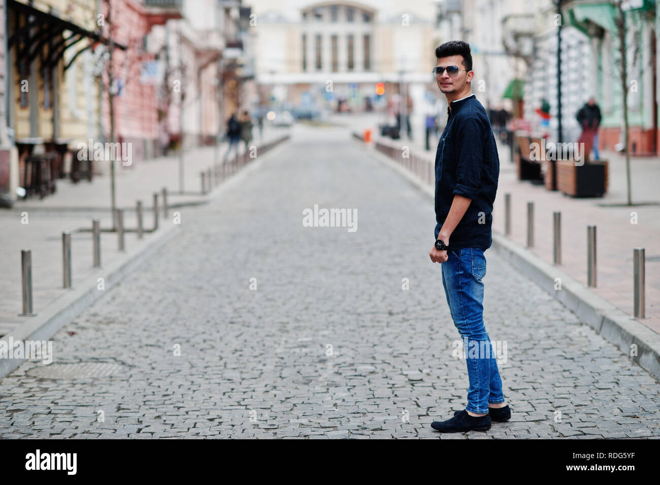 Stylish indian model man in casual clothes, black shirt and sunglasses ...