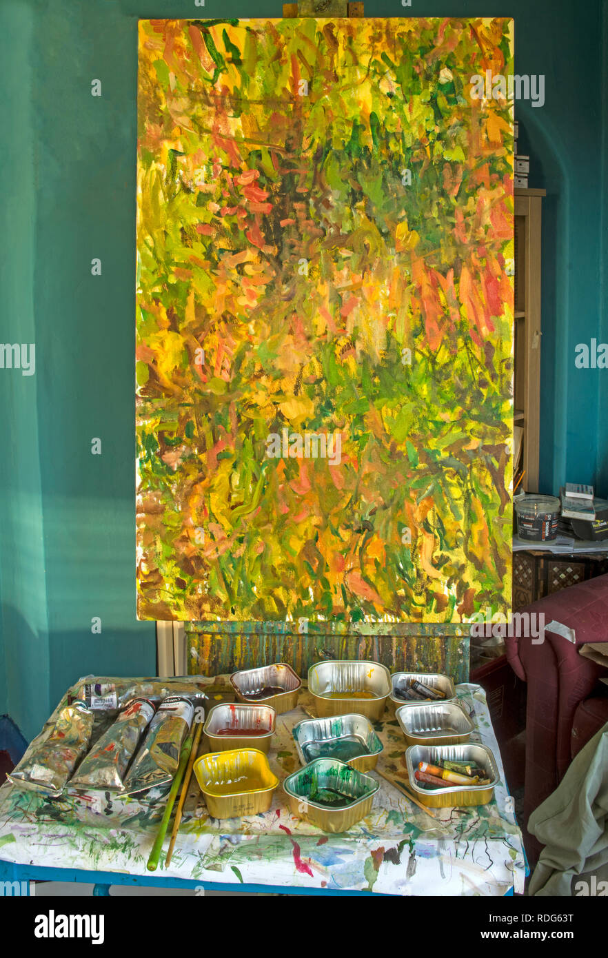 A table with mixed colours in trays used on painting which is in ...