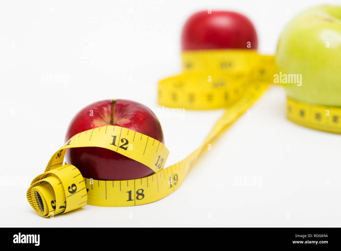 red apple and measuring tape with other apples defocused Stock Photo ...