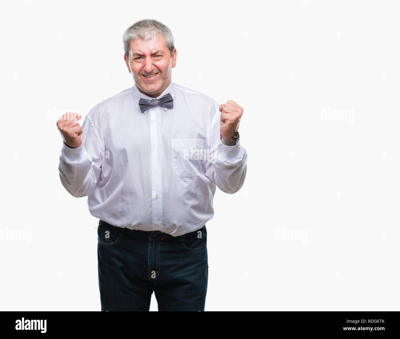 Handsome senior man wearing bow tie over isolated background ...