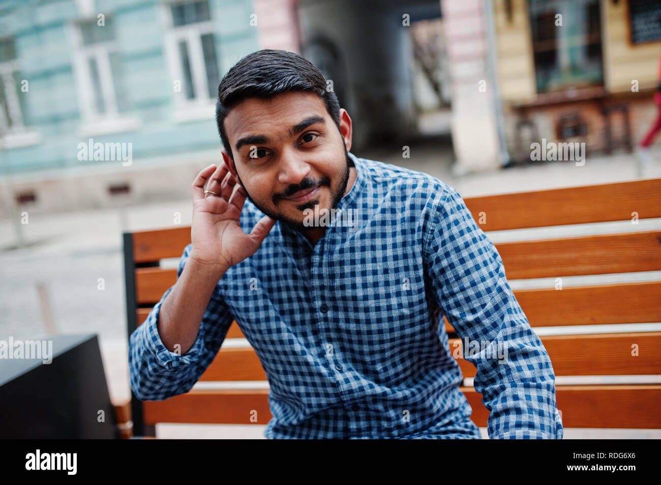 Stylish indian beard model man in casual clothes posed outdoor, sitting ... Stylish indian beard model man in casual clothes posed outdoor, sitting ...