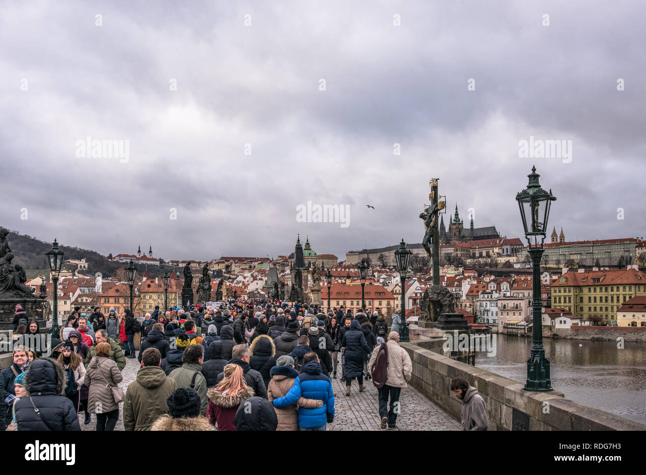 Prague. Czechia. December 2018. Tourists walk on the Charles bridge ...