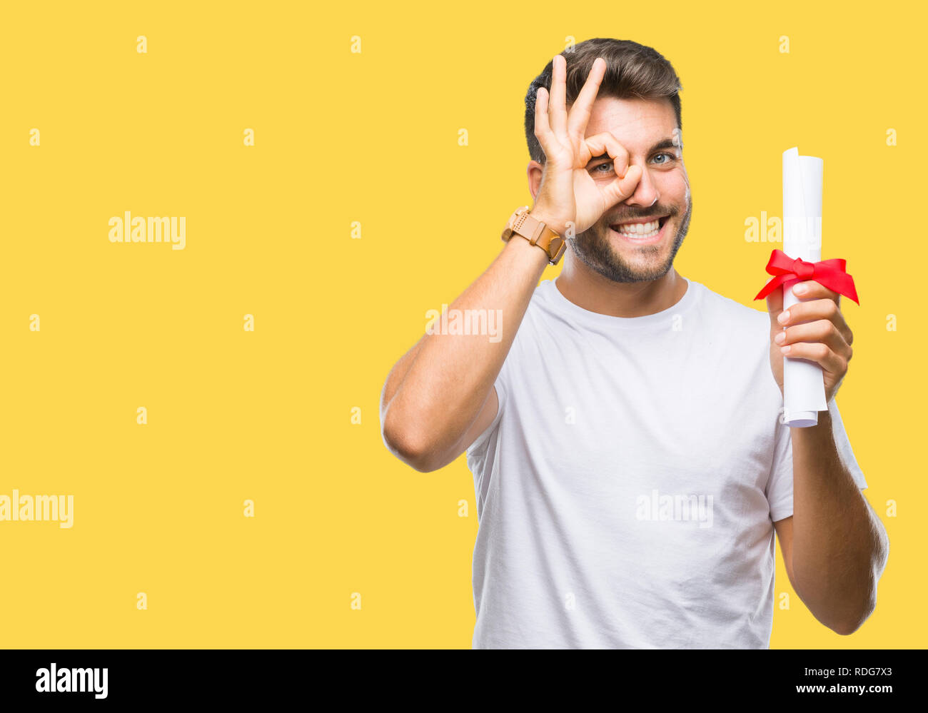 Young handsome man holding degree over isolated background with happy ...