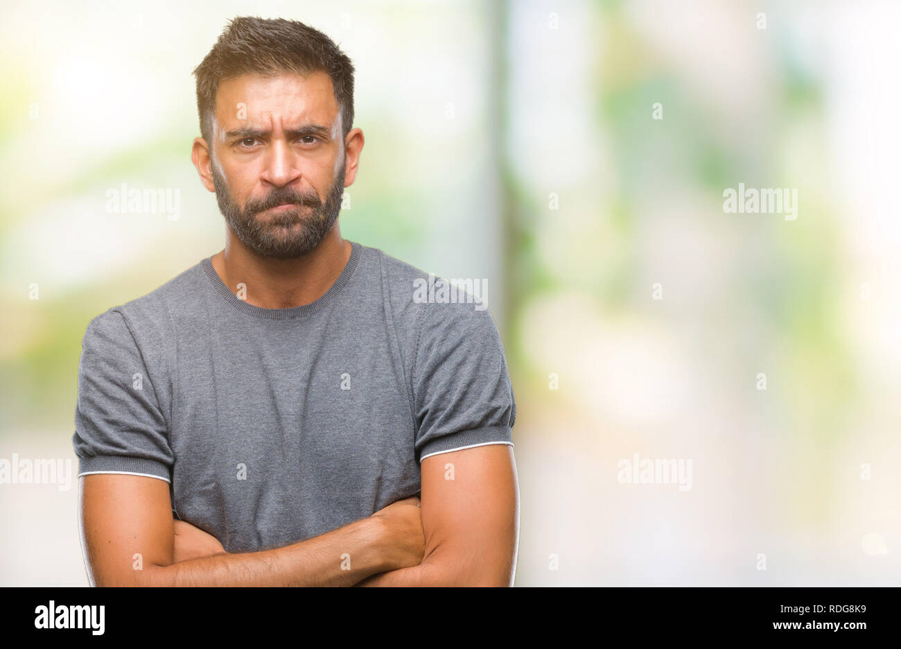 Adult hispanic man over isolated background skeptic and nervous ...