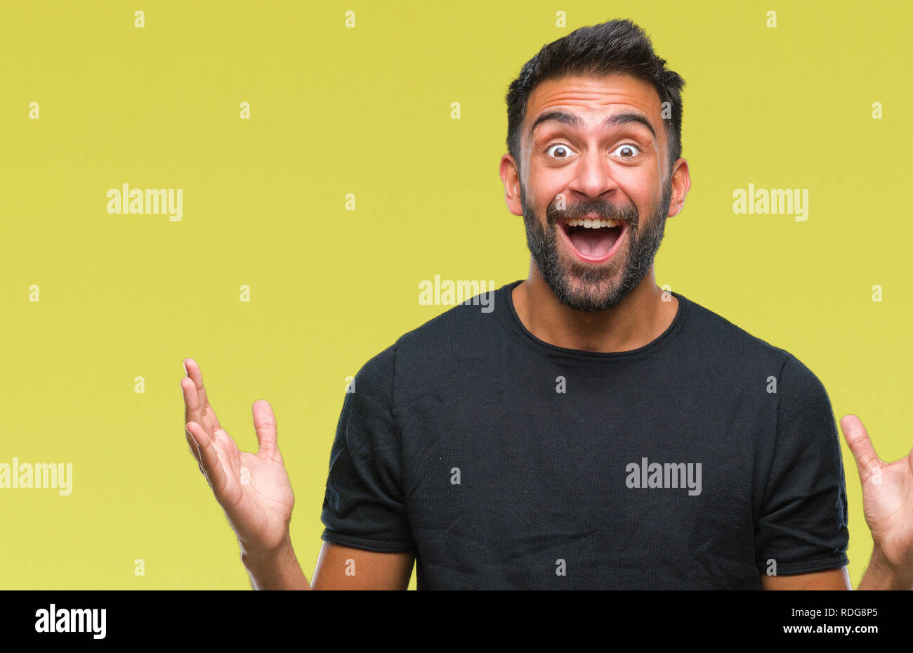 Adult hispanic man over isolated background celebrating crazy and ...