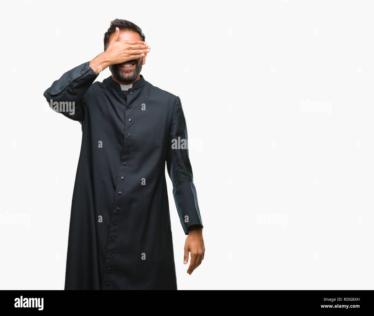Adult hispanic catholic priest man over isolated background smiling and ...