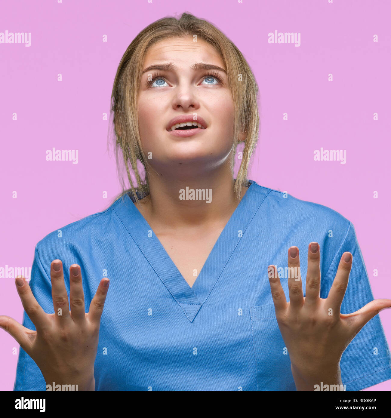 Young caucasian nurse woman wearing surgeon uniform over isolated ...