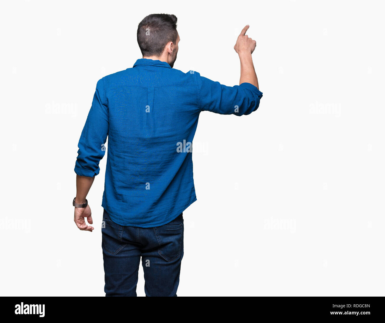 Young handsome man over isolated background Posing backwards pointing ...