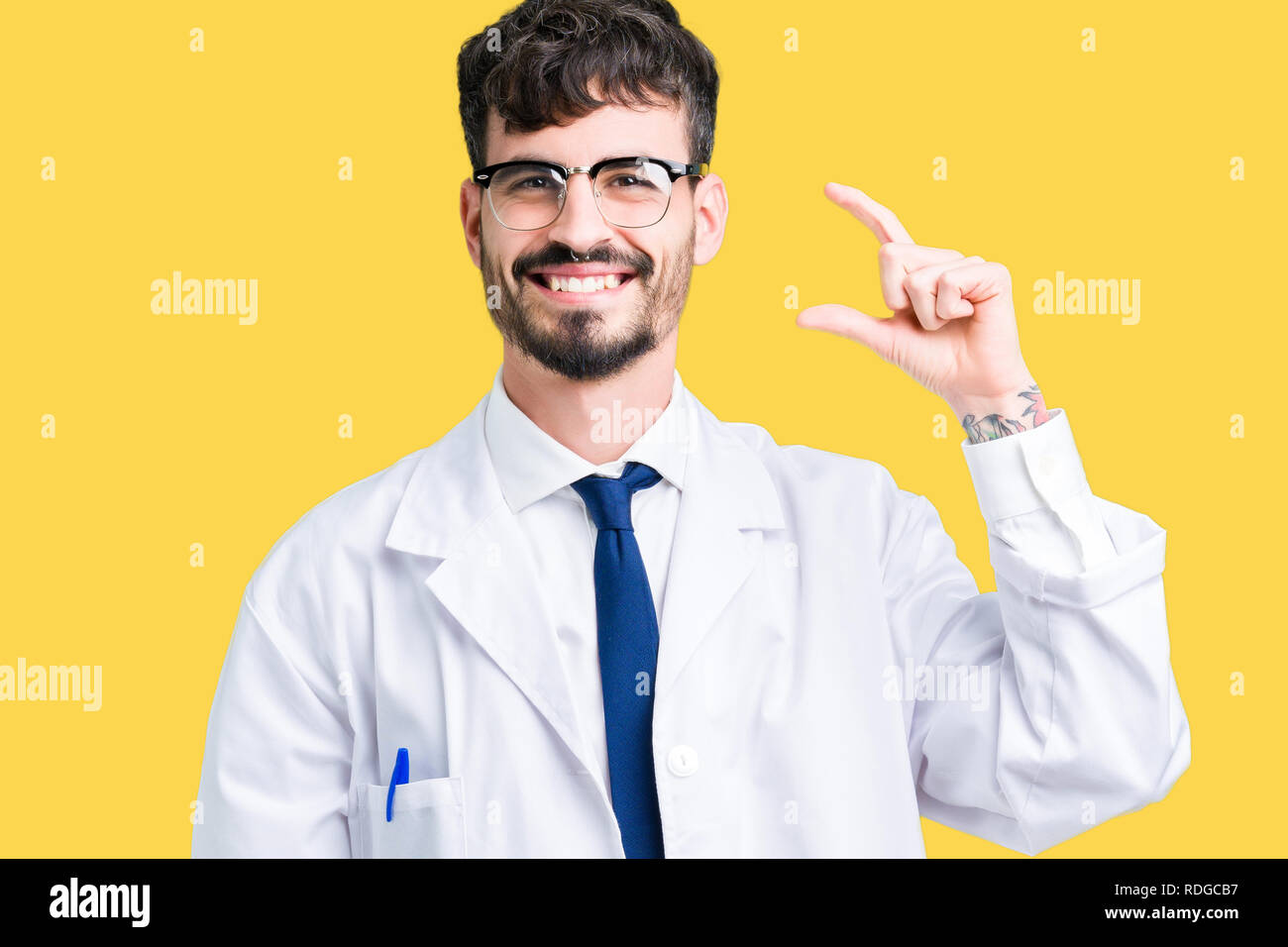 Young professional scientist man wearing white coat over isolated ...