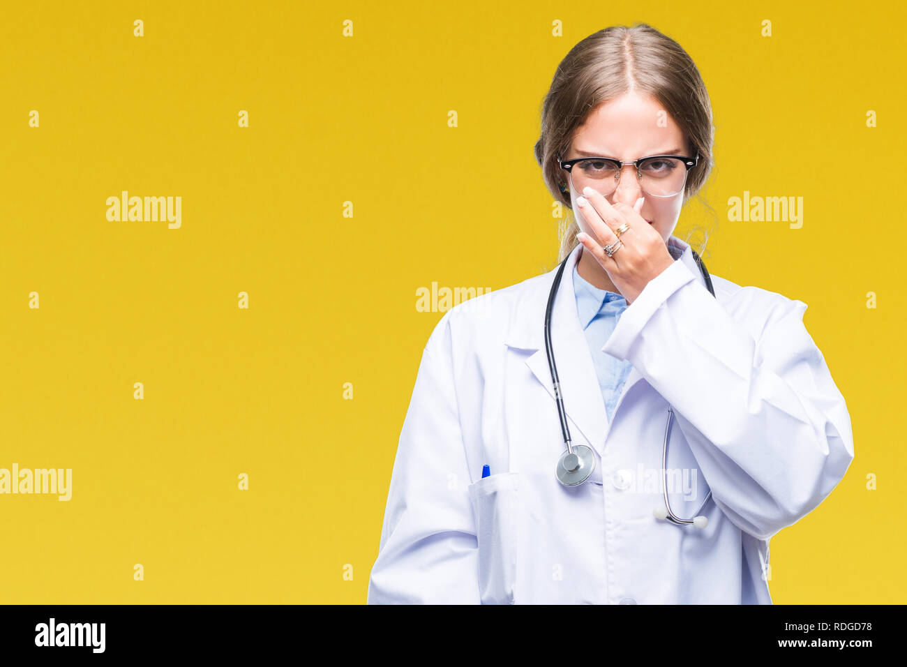 Beautiful young blonde doctor woman wearing medical uniform over ...