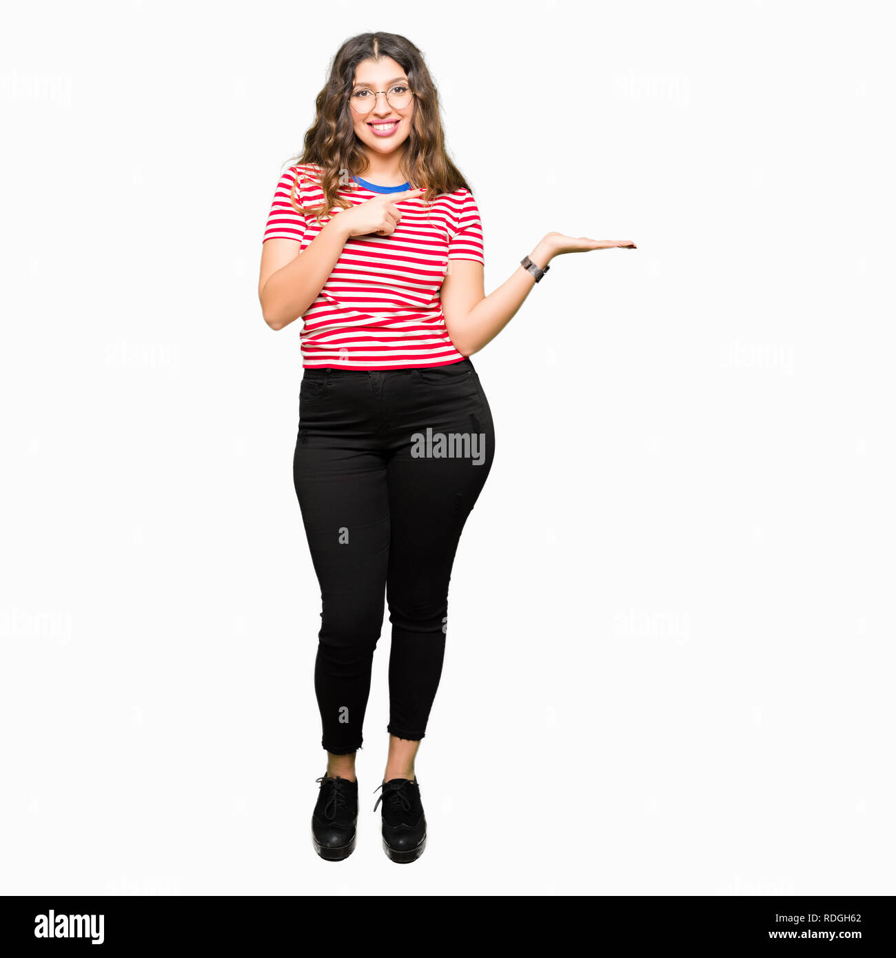 Young beautiful woman wearing glasses amazed and smiling to the camera ...