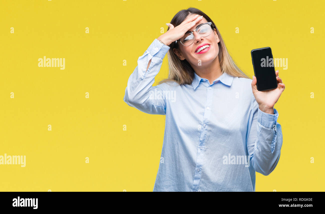 Young beautiful business woman showing blank screen of smartphone over ...