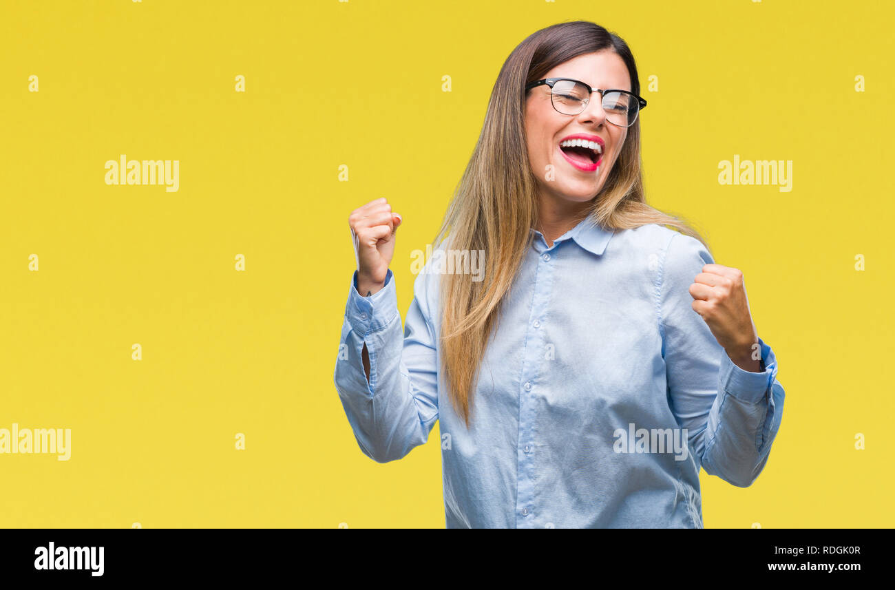 Young beautiful business woman wearing glasses over isolated background ...