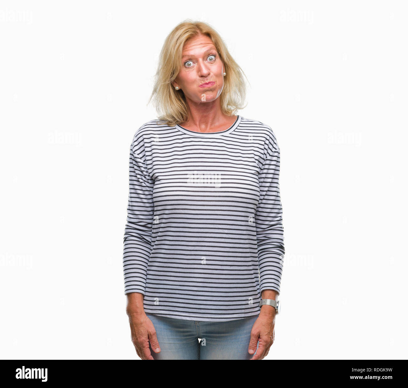 Middle age blonde woman over isolated background puffing cheeks with ...