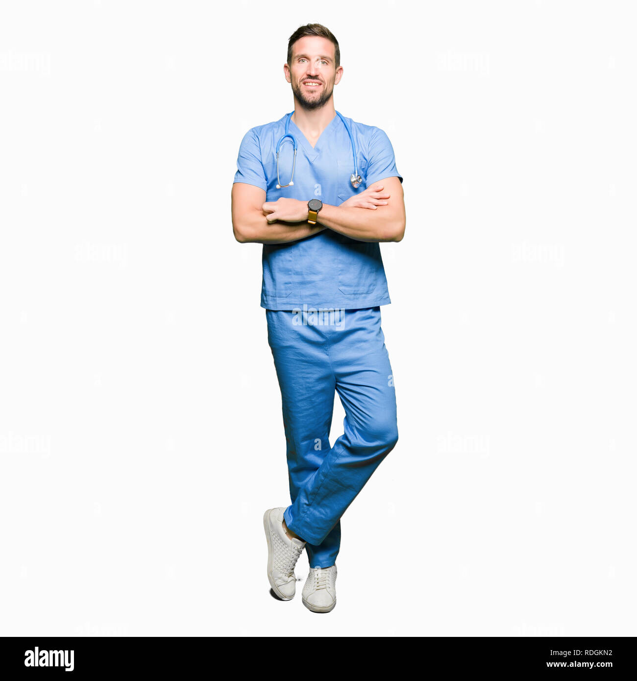 Handsome doctor man wearing medical uniform over isolated background ...