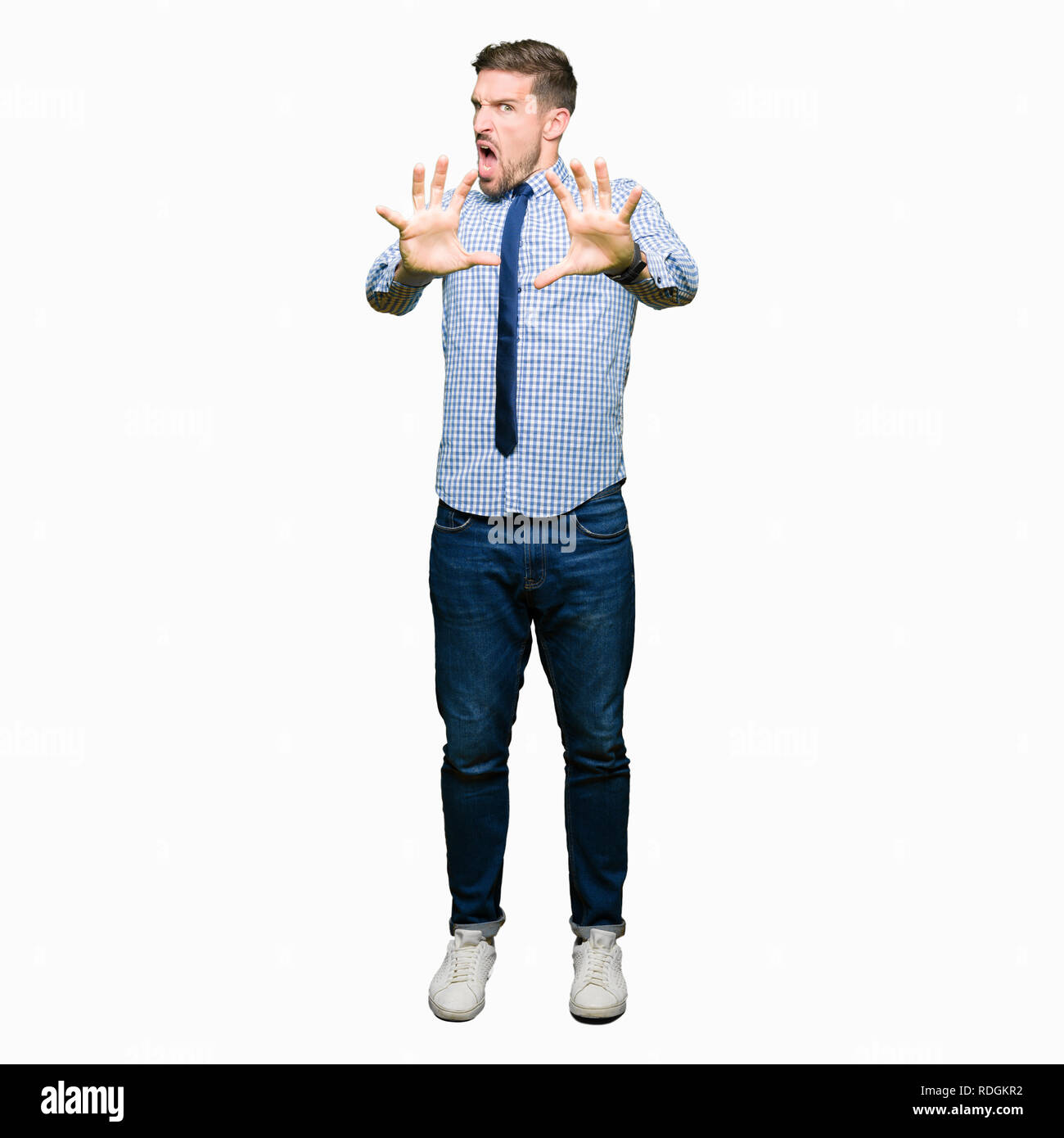 Handsome business man wearing tie afraid and terrified with fear ...