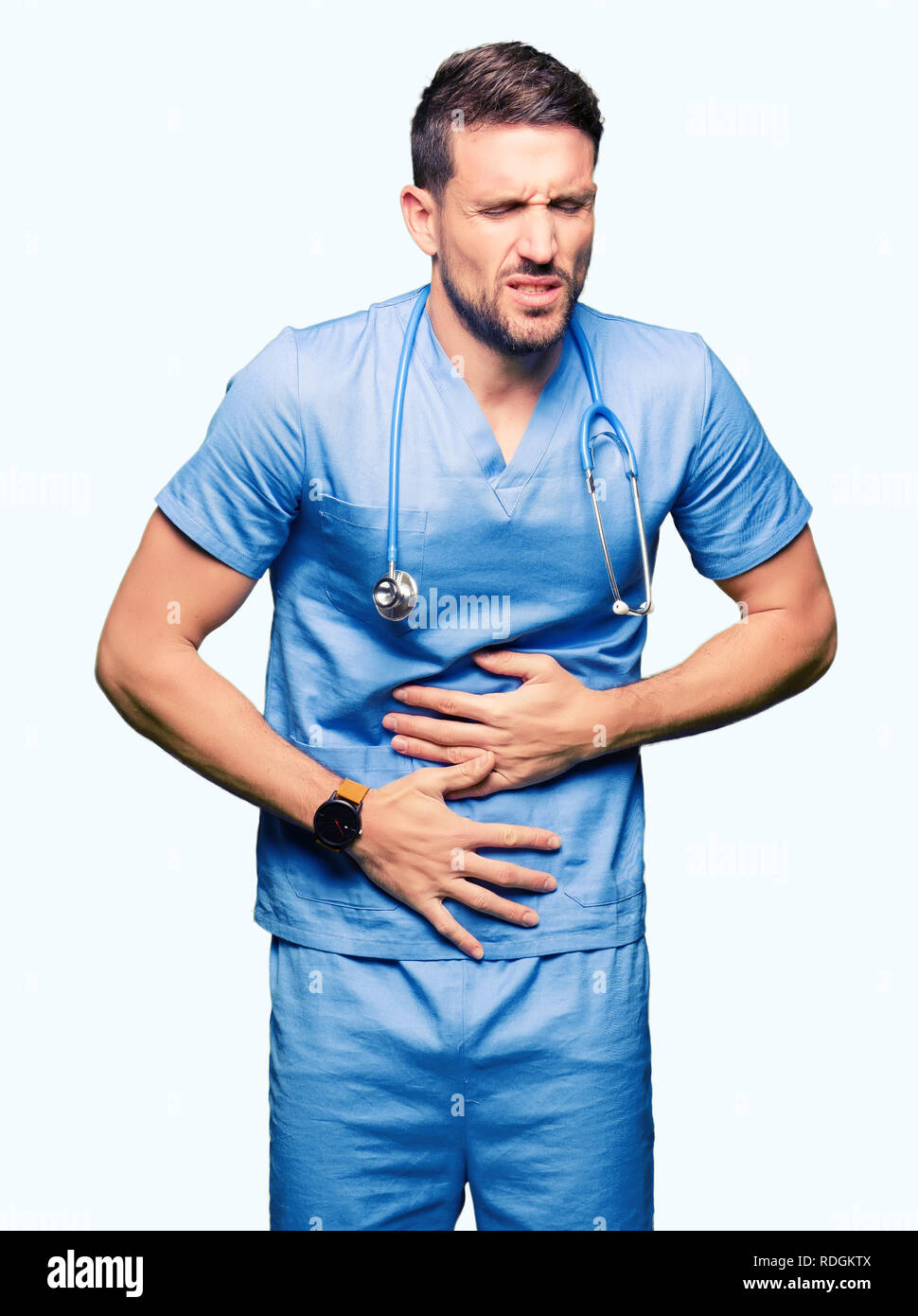 Handsome doctor man wearing medical uniform over isolated background ...