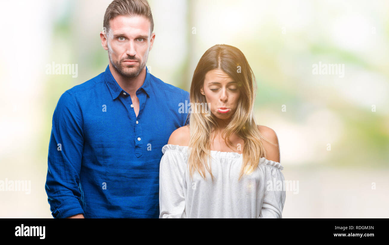 Young couple in love over isolated background depressed and worry for ...