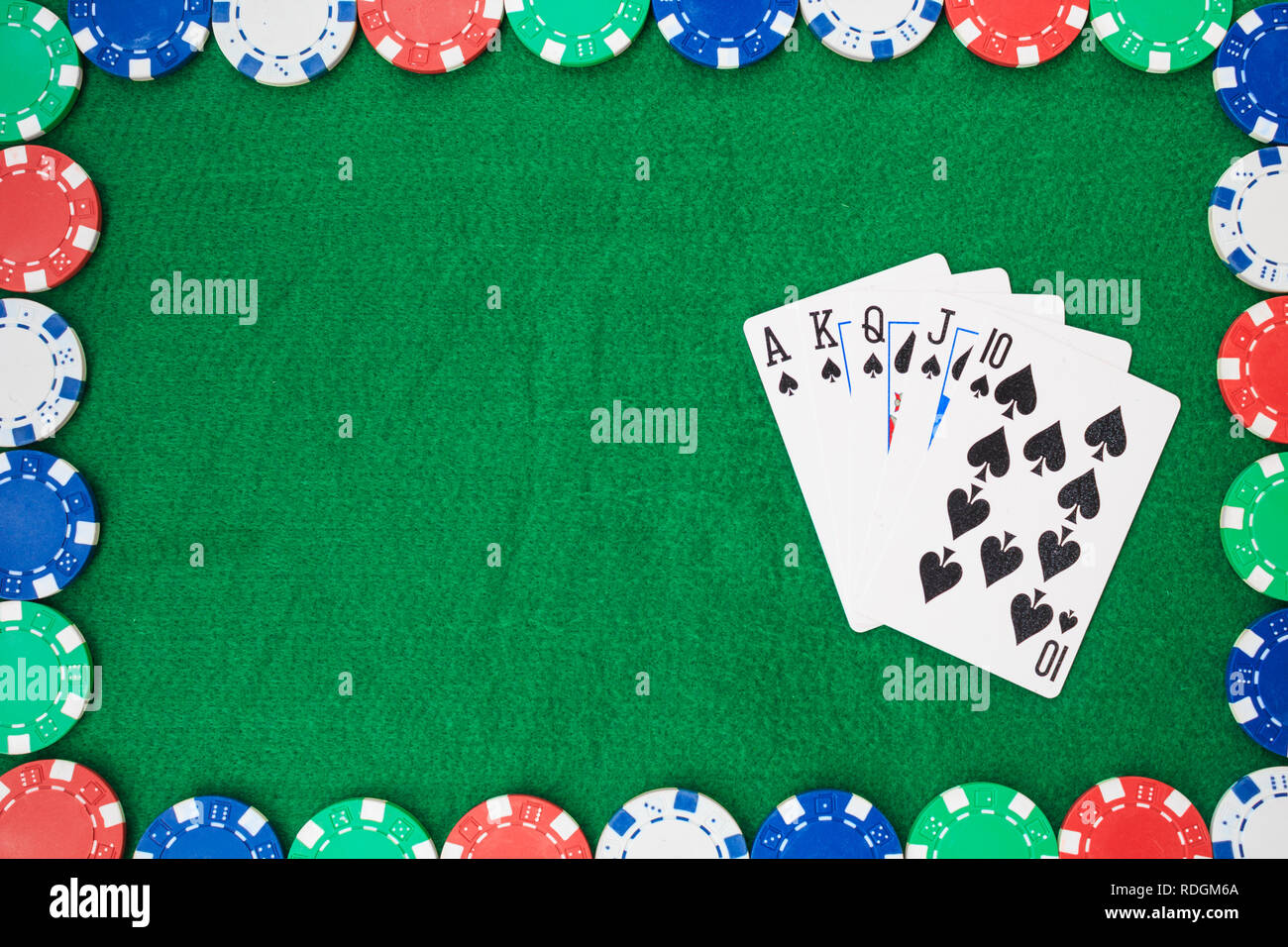 Hand of Poker, straight flush and chips frame on a felt green ...