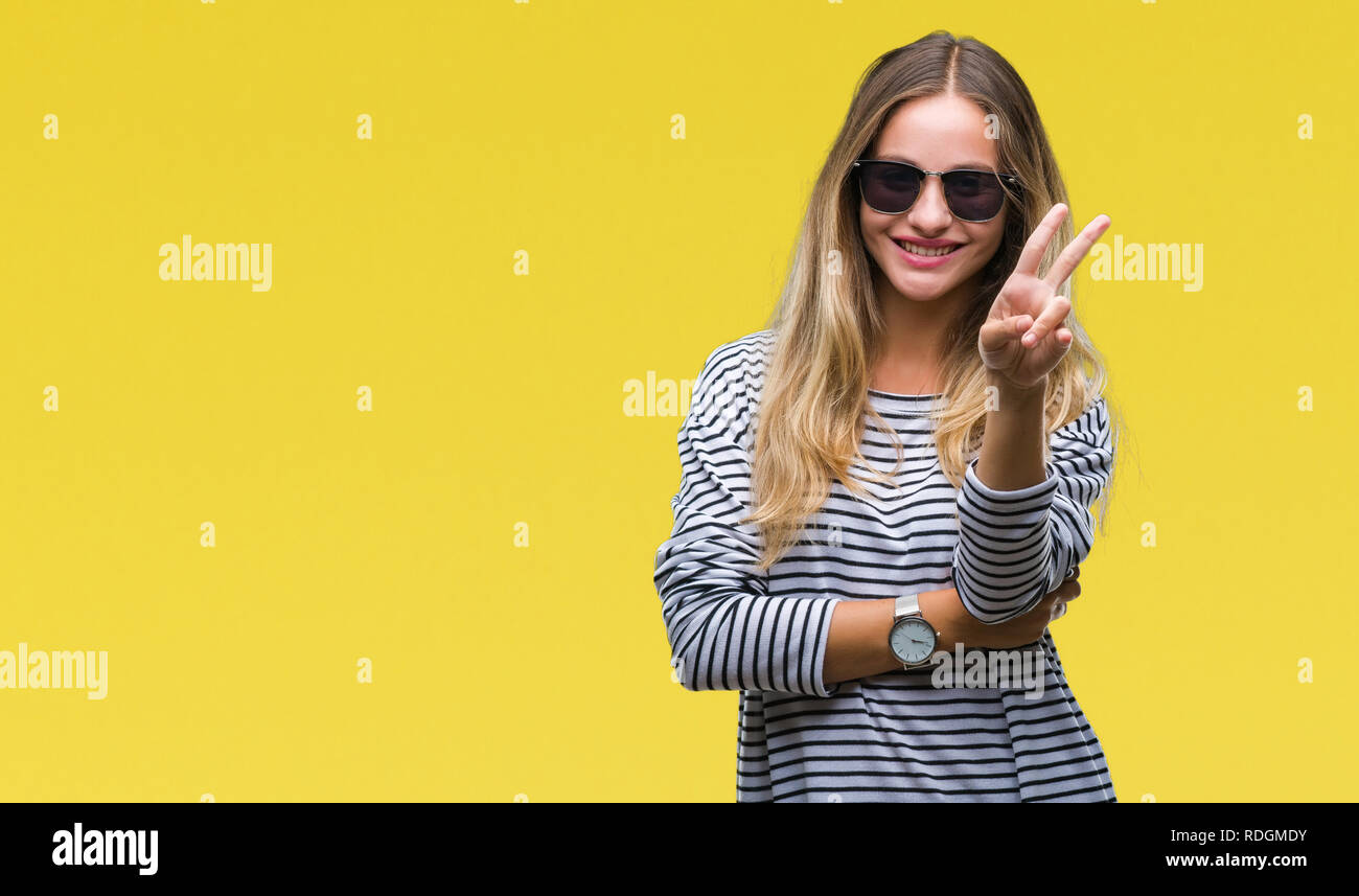 Young beautiful blonde woman wearing sunglasses over isolated ...