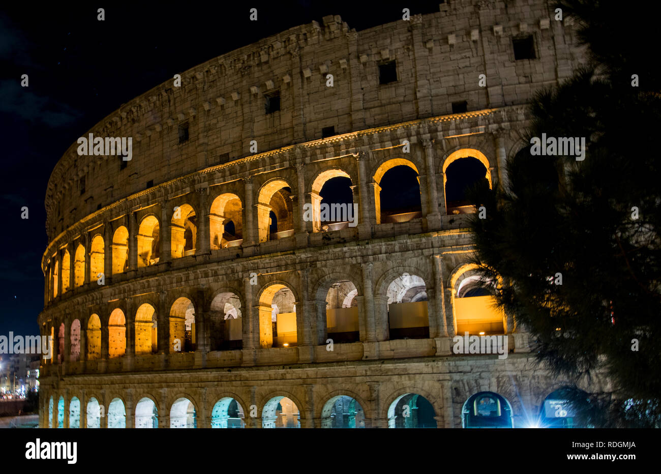 Glimpse of the Colosseum at night, in Rome illuminated by artificial ...