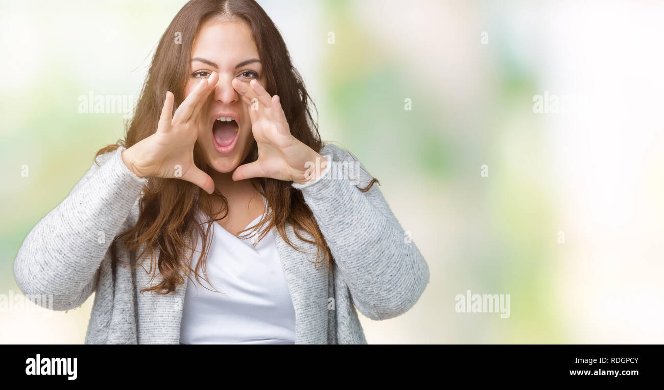 Beautiful plus size young woman wearing winter jacket over isolated ...
