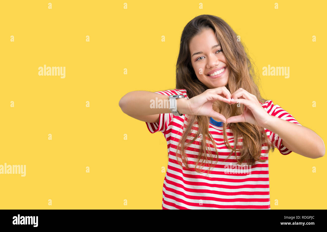 Young beautiful brunette woman wearing stripes t-shirt over isolated ...