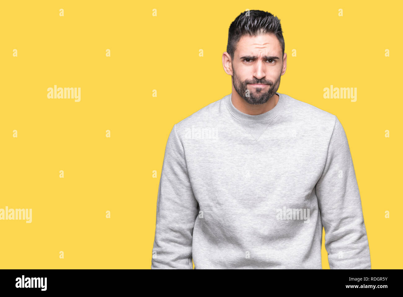 Young handsome man wearing sweatshirt over isolated background ...