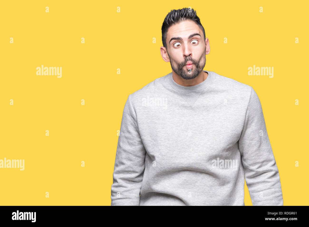 Young handsome man wearing sweatshirt over isolated background making ...