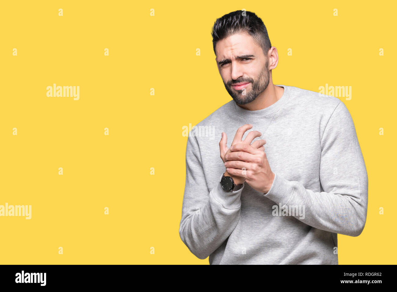 Young handsome man wearing sweatshirt over isolated background ...
