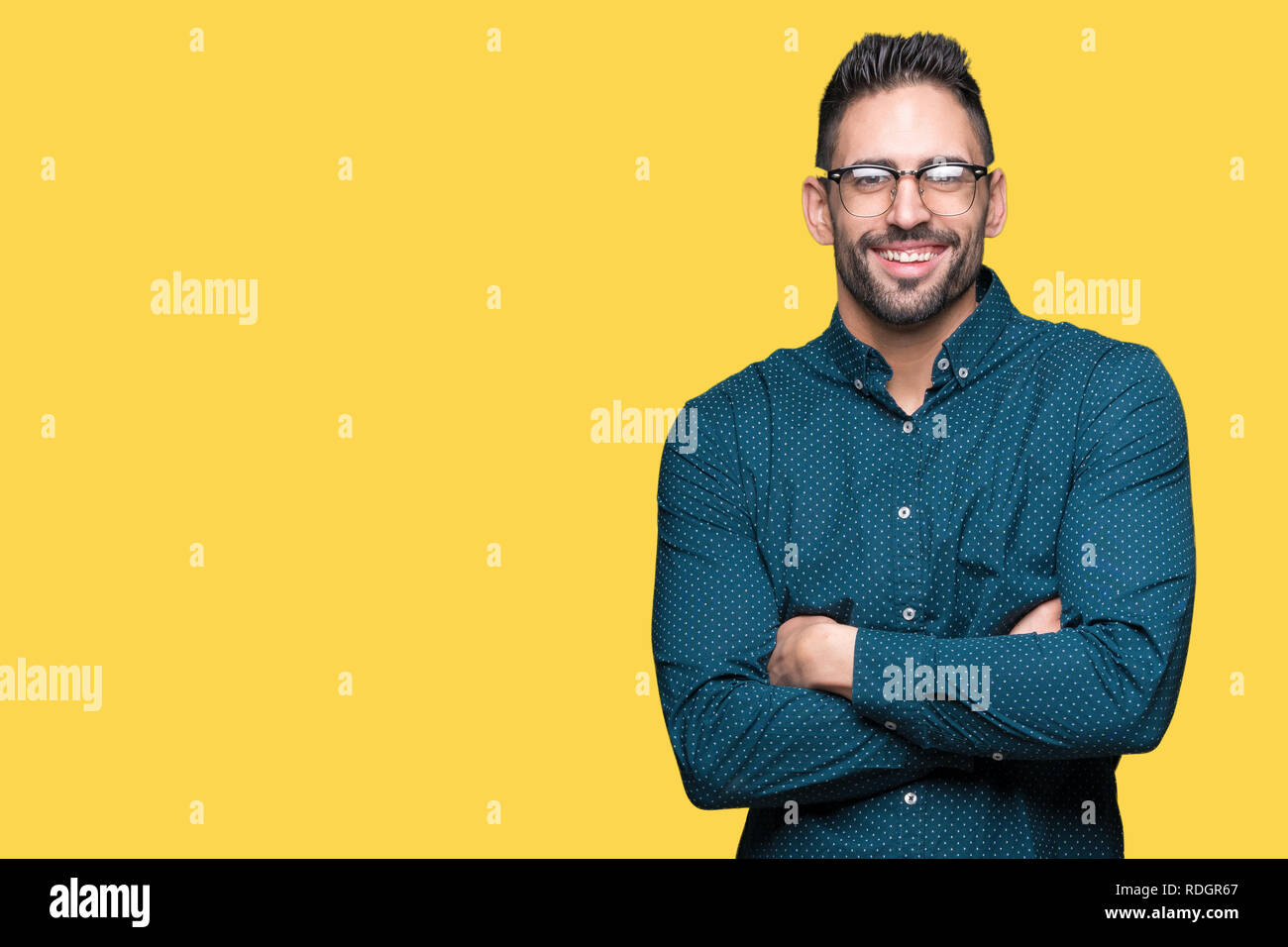 Young handsome business man wearing glasses over isolated background ...