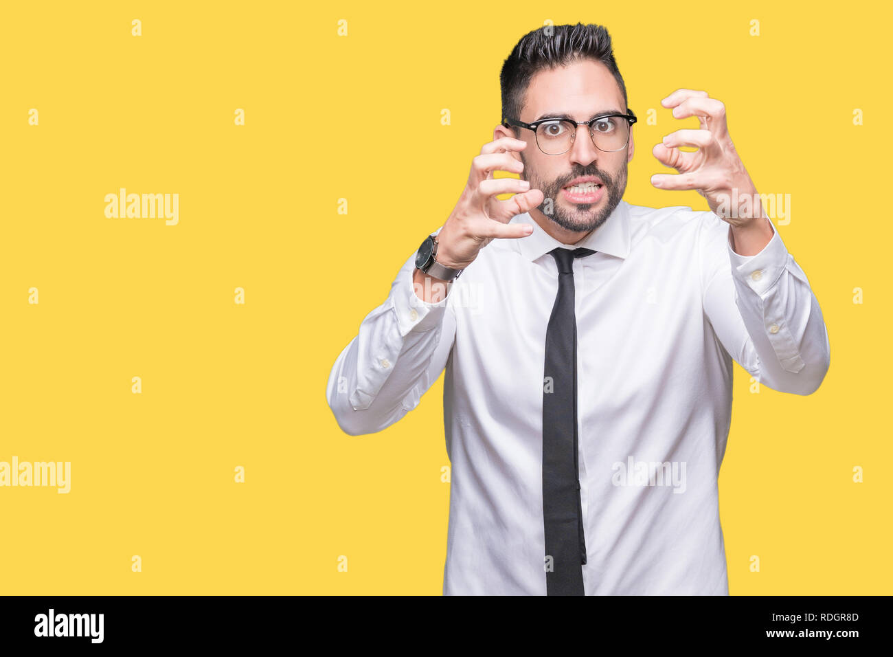 Young handsome business man wearing glasses over isolated background Shouting frustrated with ...