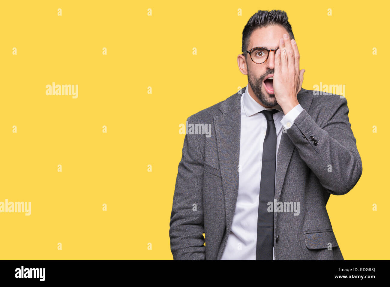 Young handsome business man over isolated background covering one eye ...