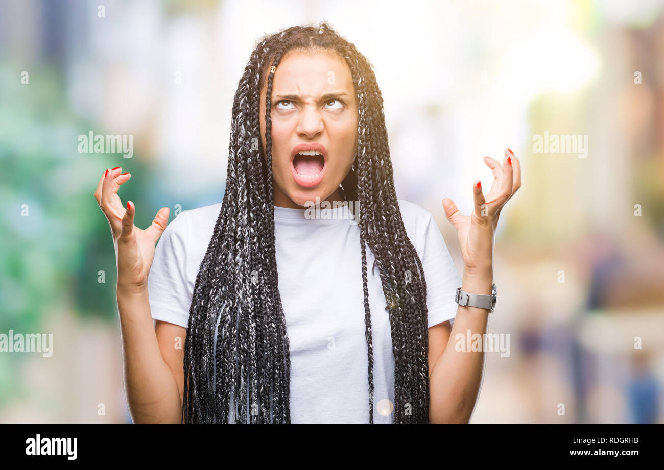 Young braided hair african american girl over isolated background crazy ...
